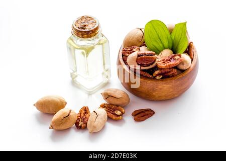 Pecan essential oil in bottle with nuts, close up Stock Photo - Alamy