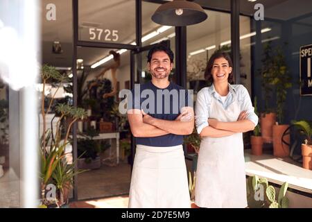 Portrait of female owners standing at doorway of boutique Stock Photo ...
