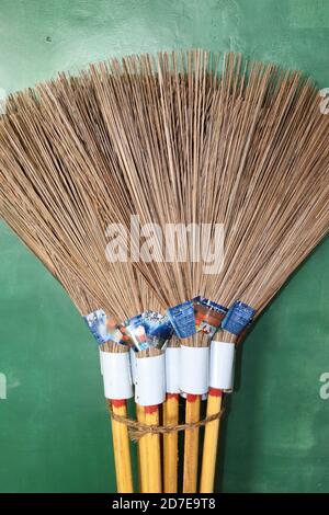 A bundle of handmade brooms which are made by coconut sticks. These are ...