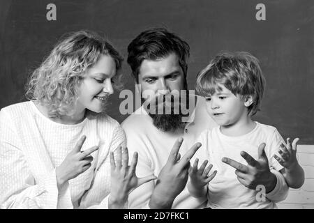 Parents encouraging their little son before the first day of school ...