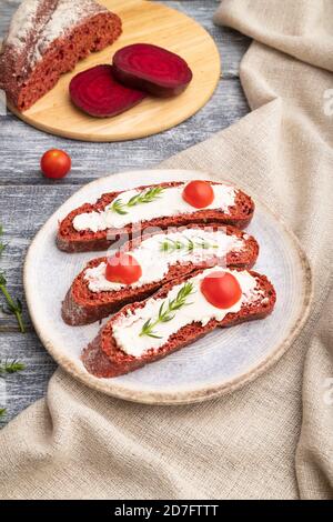 Red beet bread sandwiches with cream cheese, tomatoes and microgreen on ...