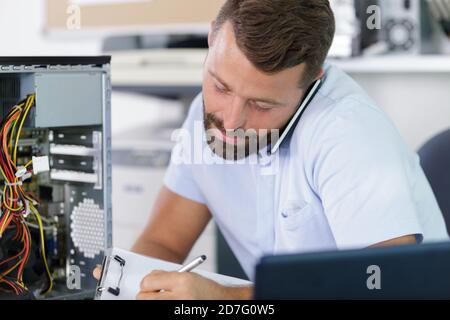 Happy customer resolving his computer problem Stock Photo - Alamy