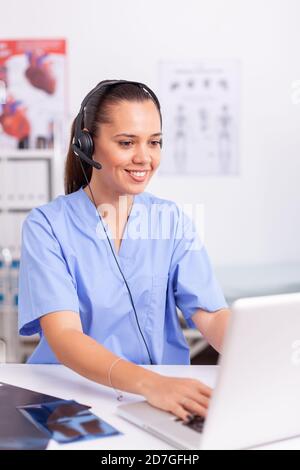 medical secretary typing report on deskop computer Stock Photo - Alamy