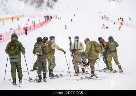 Strong man military special forces standing with guns on snow at night ...