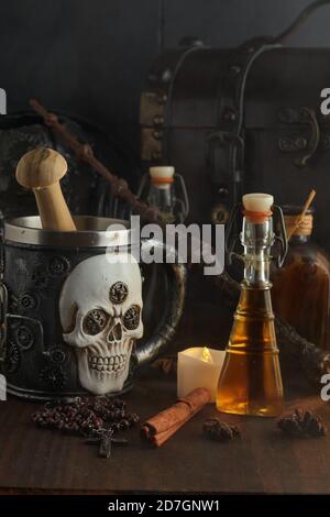 Magic potions in bottles, coffer and Magic wand on dark wooden ...