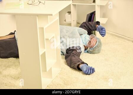 Man passed out. Shortness of breath. Man in protective equipment lay on ...