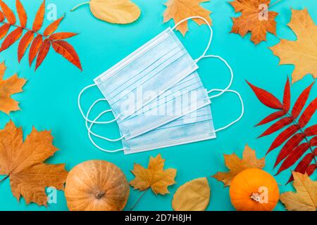 Medical mask between maple leaves. Autumn composition with mask, maple ...