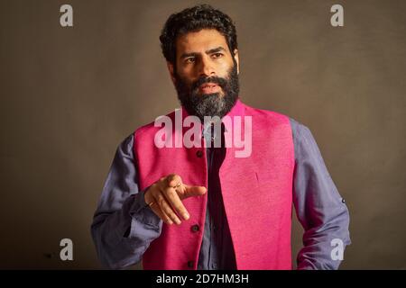 A young Indian man with a typical 'artist' and 'intellectual' look ...