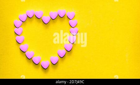 Heart-shaped tablets that form a heart shape on a yellow background ...