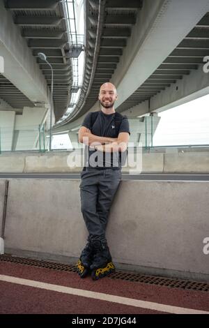 Young people roller-skating under railway arches by train station in ...