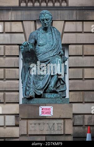 David Hume bronze statue with rubbed foot and traffic cone on his head ...