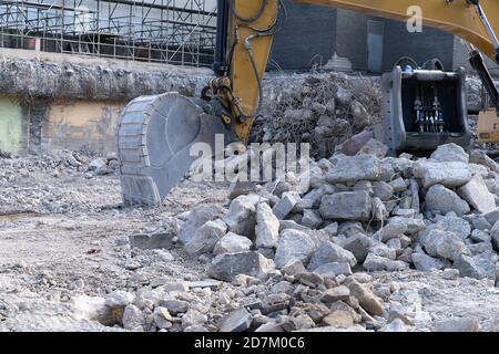 A bulldozer removes the rubble from a building destroyed in an Israeli ...