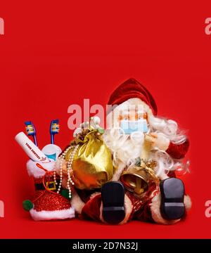Christmas dentistry - tooth with red santa claus hat, mittens on a blue ...