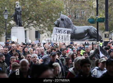 People pass through Trafalgar Square, London, protesting against the ...