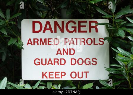 Round 'Keep out' warning sign with person holding up hand in red circle ...