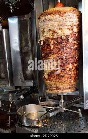 meat cooking on skewer for authentic greek gyro sandwich as ...
