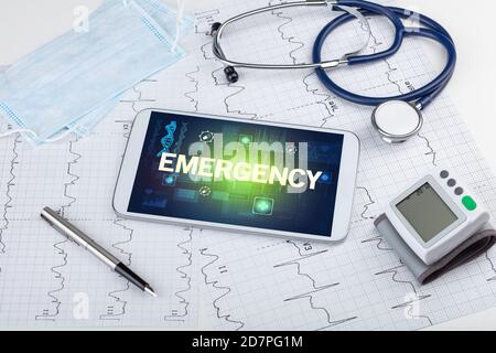 Tablet pc and medical stuff with EMERGENCY inscription, prevention ...