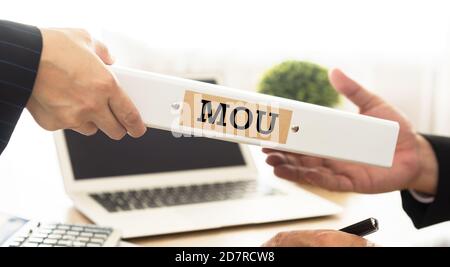 MOU, memorandum of understanding document folder on desk in meeting ...