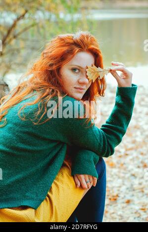 portrait of happy redhead woman in coat looking away Stock Photo - Alamy