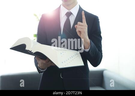 Lawyer showing number one finger with law book Stock Photo - Alamy