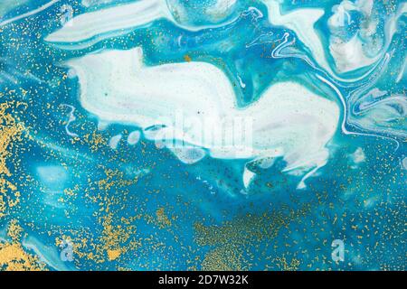 Gold and light blue mixed inks spilled background. Turquoise texture ...
