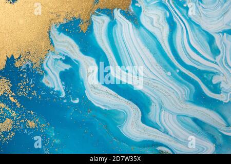 Gold and light blue mixed inks spilled background. Turquoise texture ...