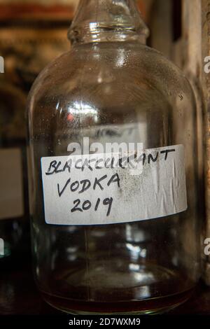 An empty bottle for alcoholic beverages made of transparent glass of a ...