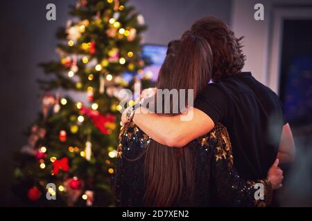 happy couple hugging at christmas tree Stock Photo - Alamy
