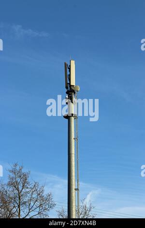 Mobile phone mast with various transmitters and a clear blue sky ...