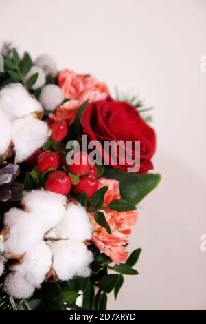 Christmas decoration with red roses, fir, brunia and cinnamon sticks ...