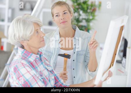 Woman and elderly father discussing installing faucet Stock Photo - Alamy