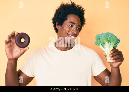 Man holding broccoli and thinking Stock Photo - Alamy