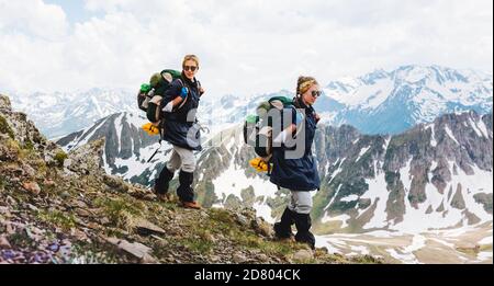 Girl Traveler hiking with backpack at rocky mountains landscape Travel ...