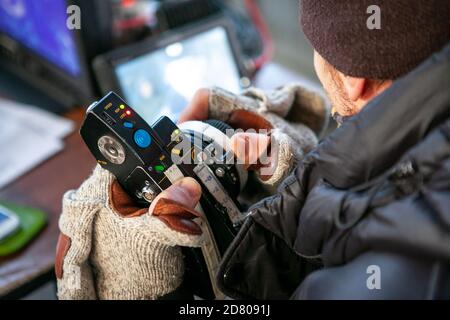 Focus puller hold the wireless follow focus system during the filming ...