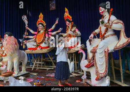 Dhaka, Bangladesh. 26th Oct, 2020. Hindu devotees carry an idol of the ...