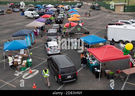 Cars line up for a pop-up food distribution event to provide extra ...