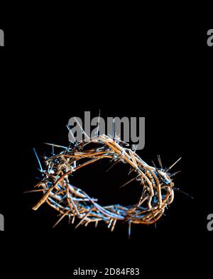 The crown of thorns lie on an isolated black background, with a red ...