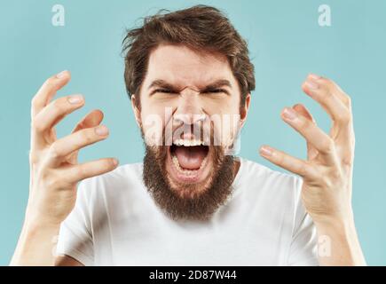 irritable man with beard on blue background portrait cropped view Stock ...