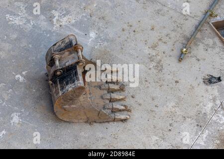 Digger claw of excavator, isolated concrete in building site, top down ...