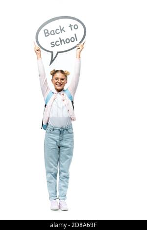 Positive schoolchild with backpack holding speech bubble on blue ...