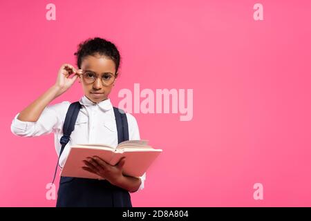 African American schoolgirl in eyeglasses examining computer program on ...