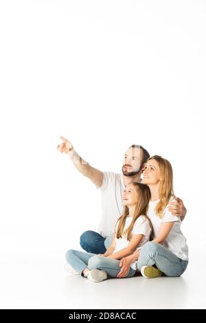 Happy daughter with mom point finger at selected christmas tree ...