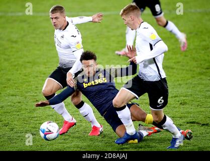 Swansea City's Jake Bidwell (centre) and Barnsley's Mads Andersen ...