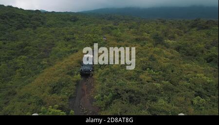 Cars driving along the black volcanic sand to Pacaya volcano in ...