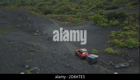 Cars driving along the black volcanic sand to Pacaya volcano in ...