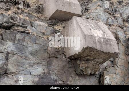 Concrete blocks on the side of a cliff. These blocks anchor the ends of ...