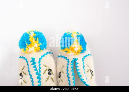 Pair of Greek slippers with pumpons on gray background Stock Photo - Alamy