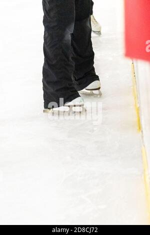 View of a figure skater and her coach feet at the figure skating ...