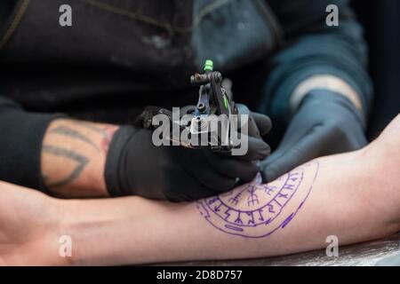 Tattoo artists work at Bodycraft Tattoo and Piercing Studios in ...