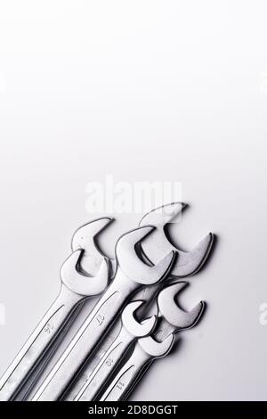 Wrenches of different sizes accompanied by screws of various sizes and ...